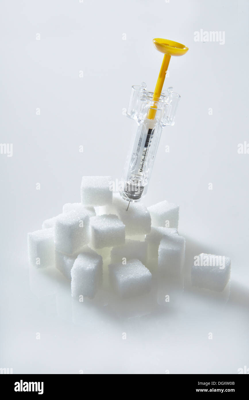 Syringe filled with insulin, insulin injection sticking in a pile of ...