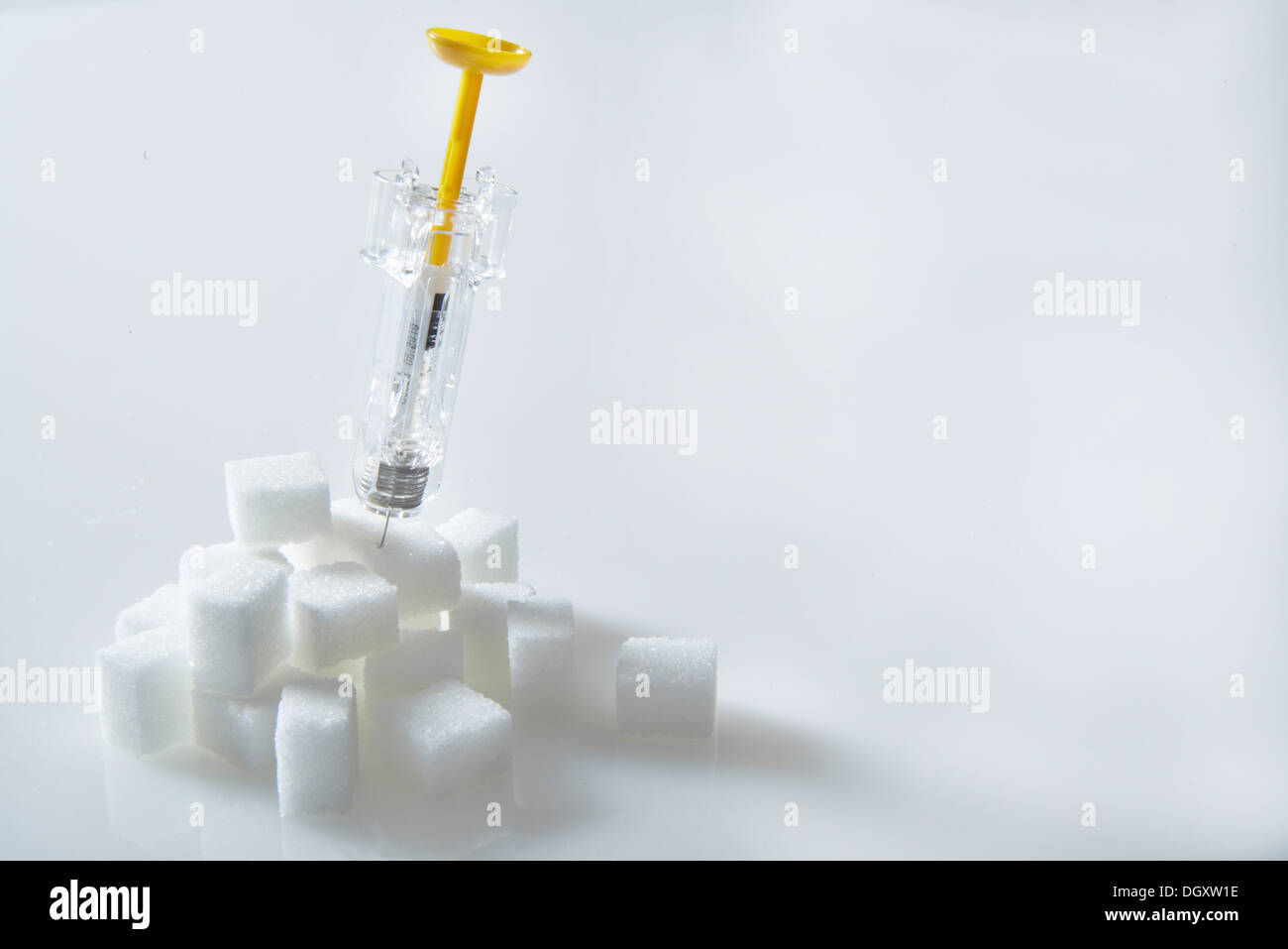 Syringe filled with insulin, insulin injection sticking in a pile of ...