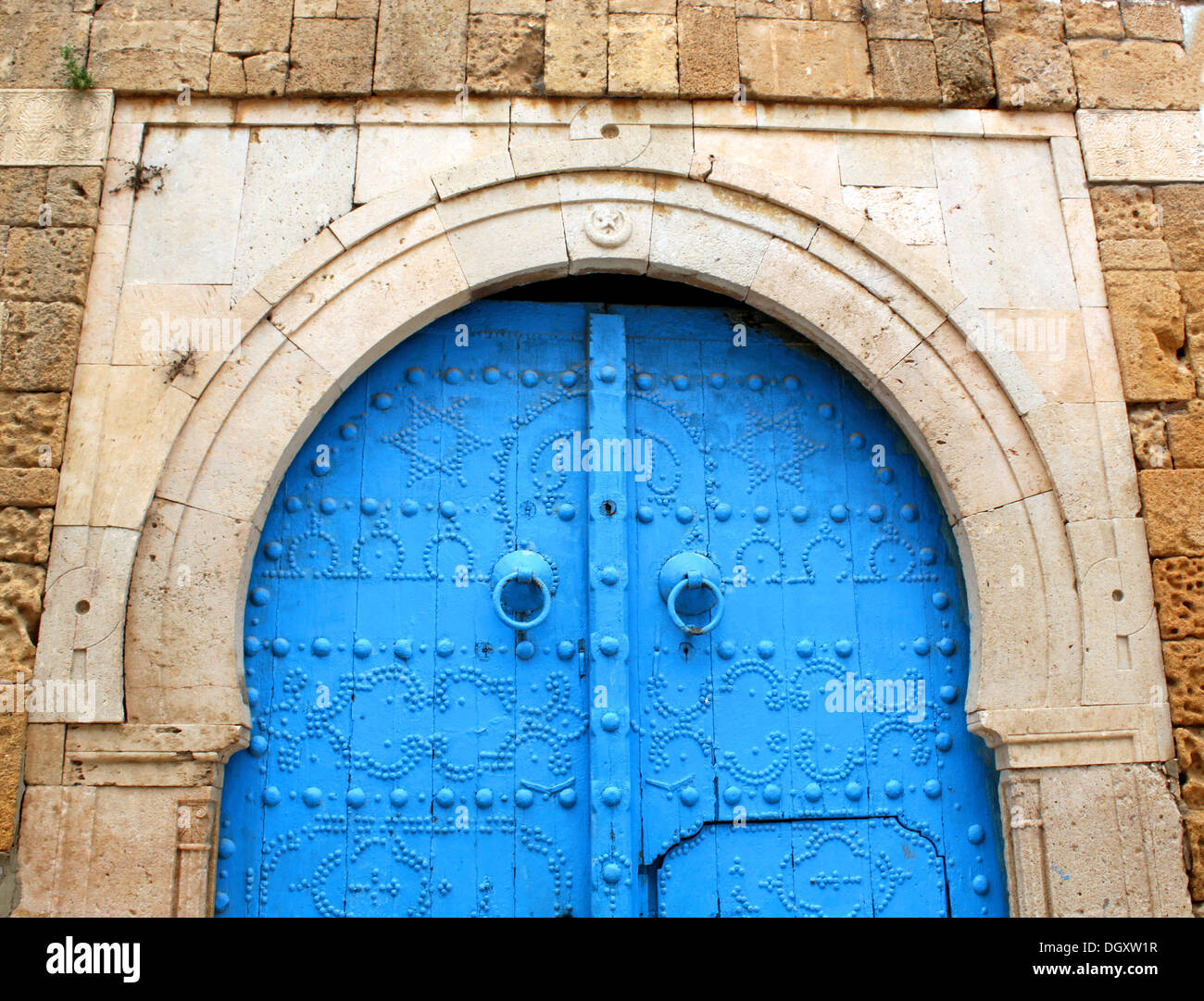 Blue gate in the stone wall Stock Photo - Alamy