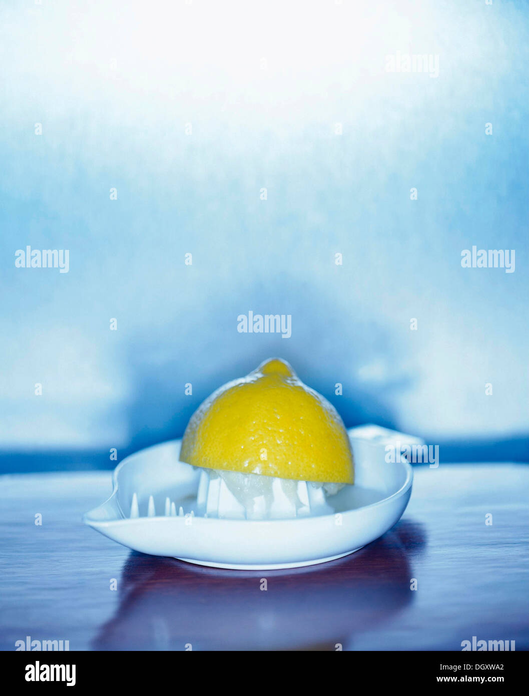 Squeezed lemon in a lemon squeezer Stock Photo - Alamy