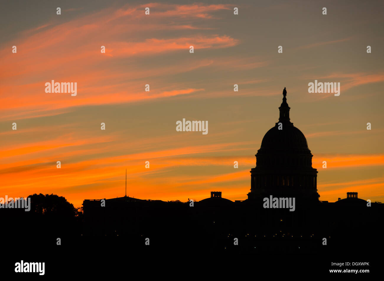 WASHINGTON DC, USA - The sun rises behind a silhouette of the dome of ...