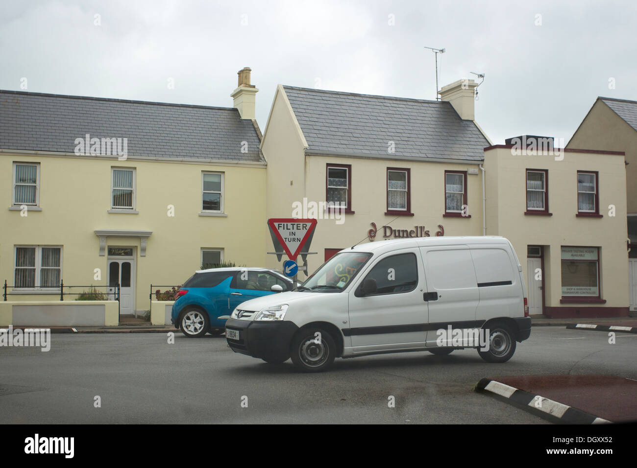 filter in turn sign and roundabout in Jersey Stock Photo - Alamy