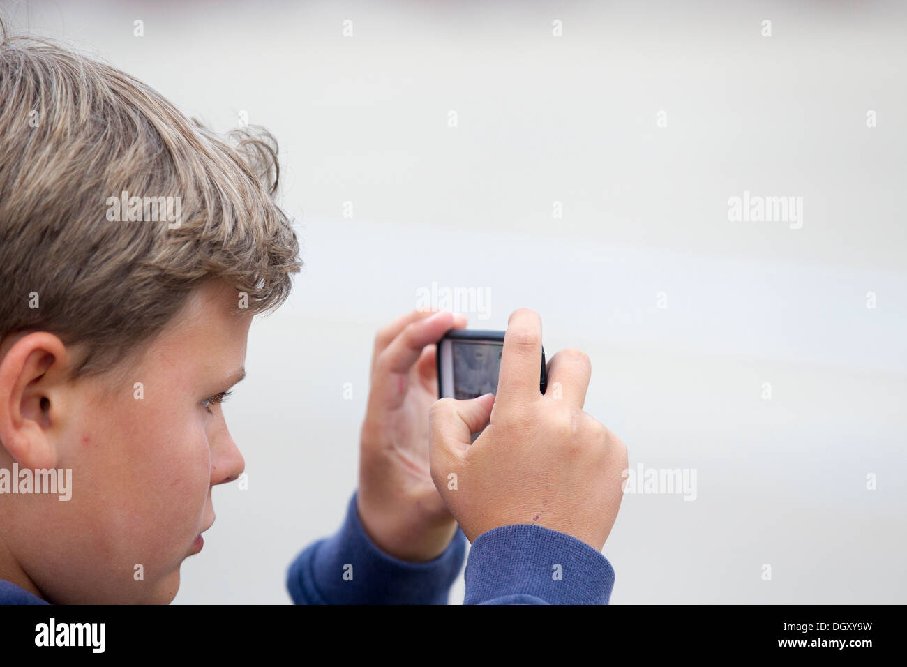 young boy taking picture on mobile phone Stock Photo - Alamy