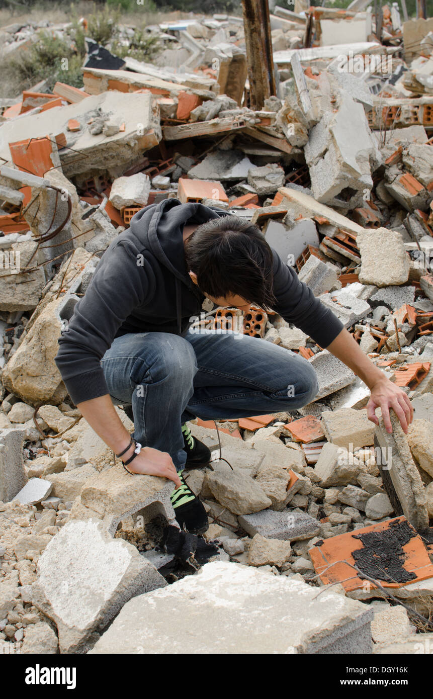 Guy rummaging in a whole lot of construction debris Stock Photo - Alamy