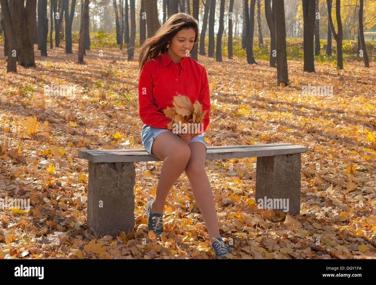 Girl sitting on a bench hi-res stock photography and images - Alamy