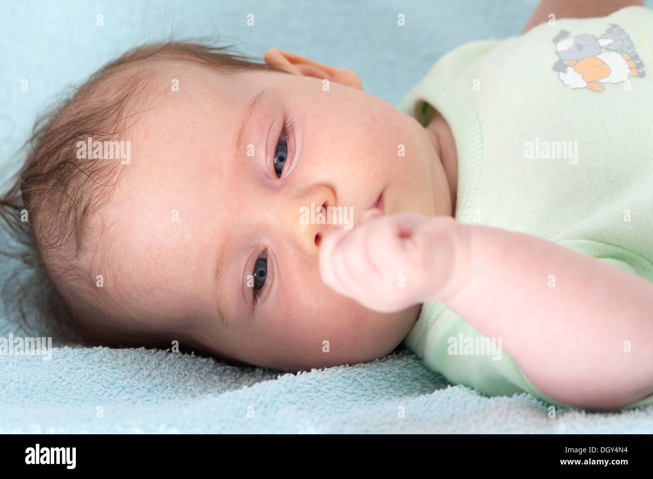 Little baby girl looking at her hand concentrating Stock Photo - Alamy