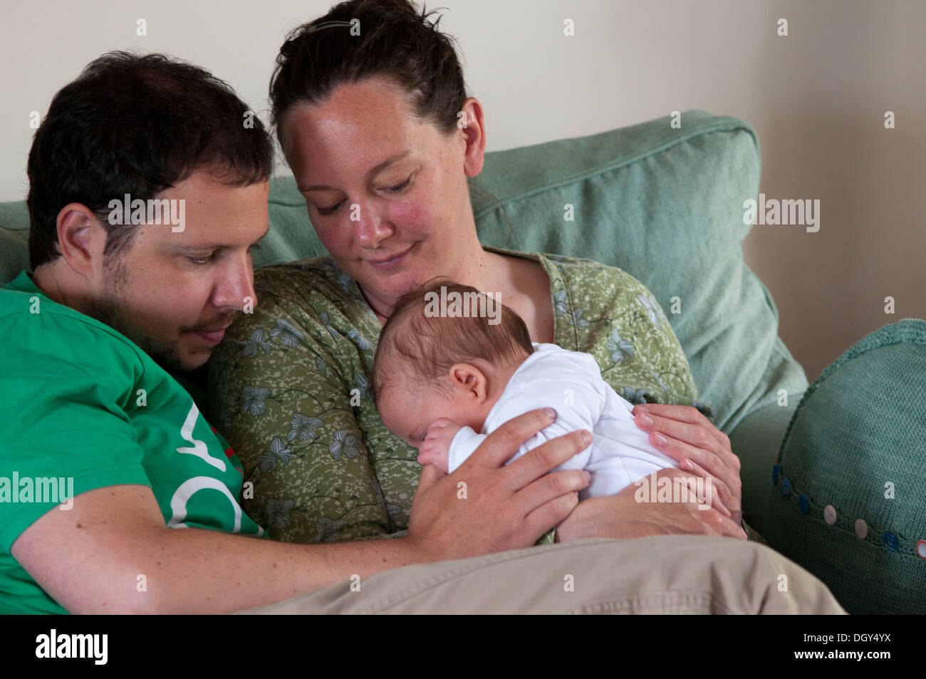 Couple holding and cuddling their little baby girl Stock Photo - Alamy