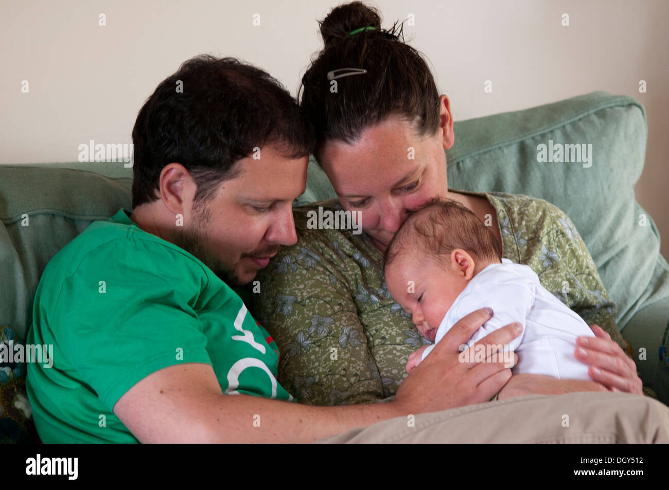Couple holding and cuddling their little baby girl Stock Photo - Alamy
