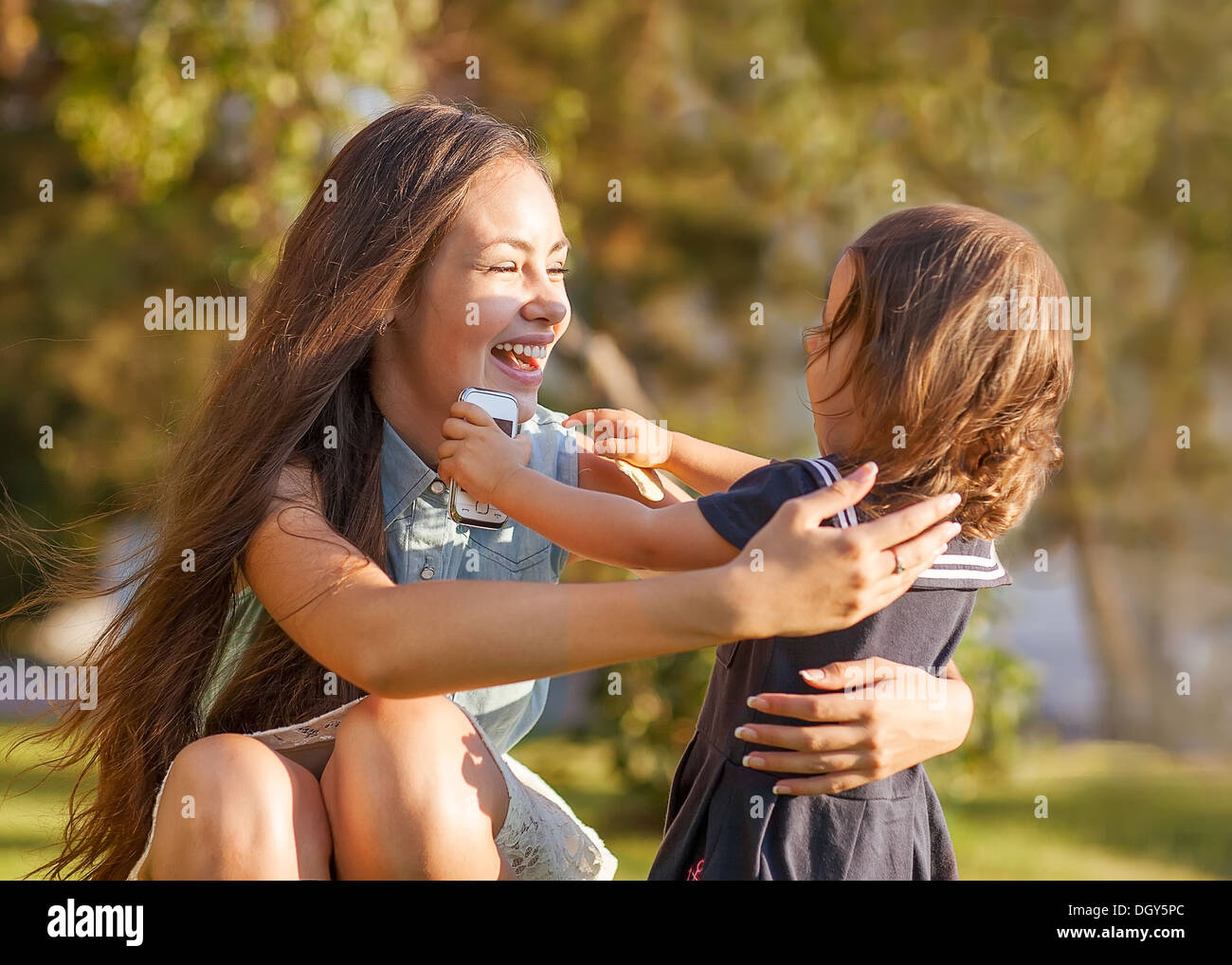 Two sisters having fun at the park Stock Photo - Alamy