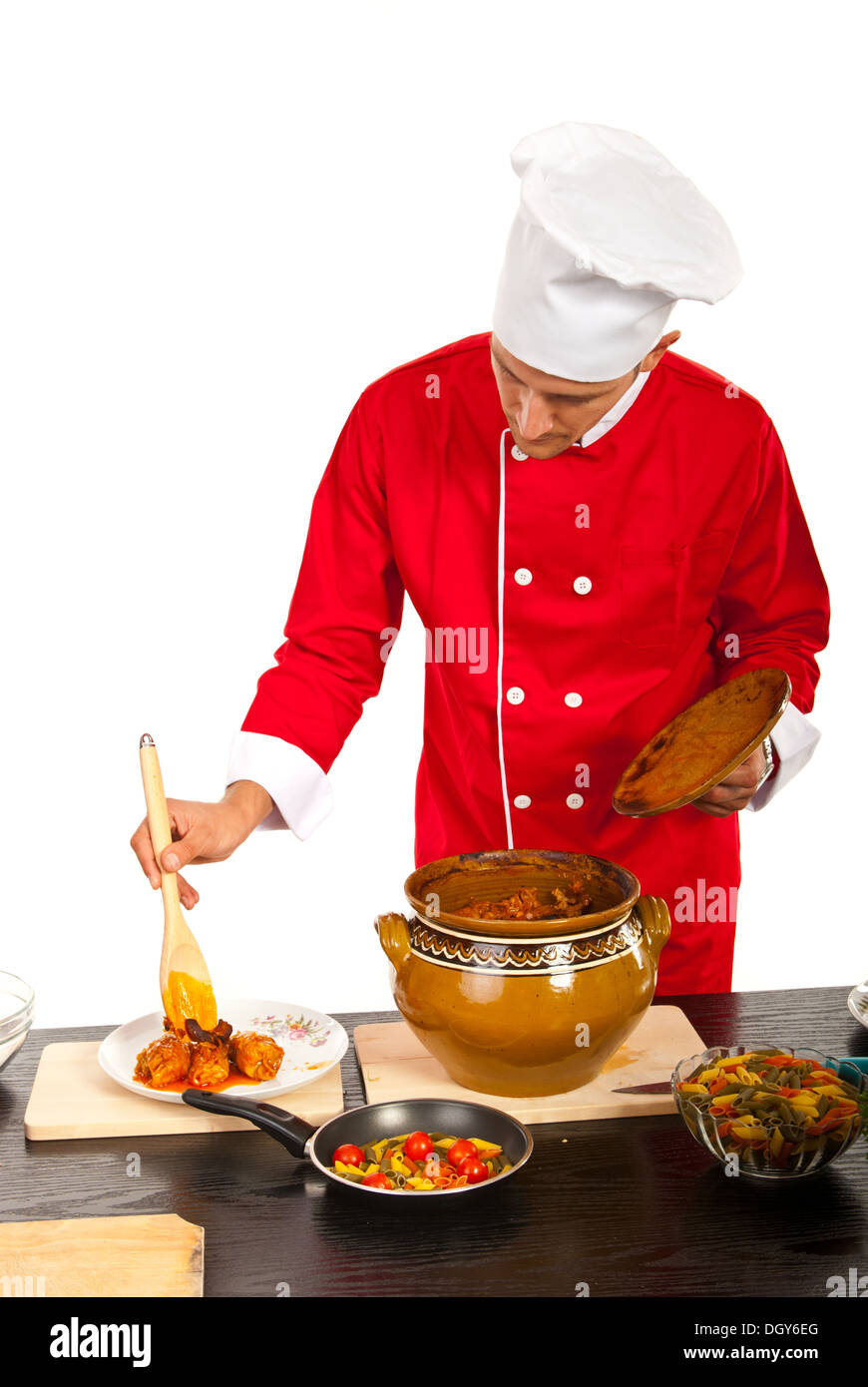 Chef male putting food on plate in kitchen Stock Photo - Alamy
