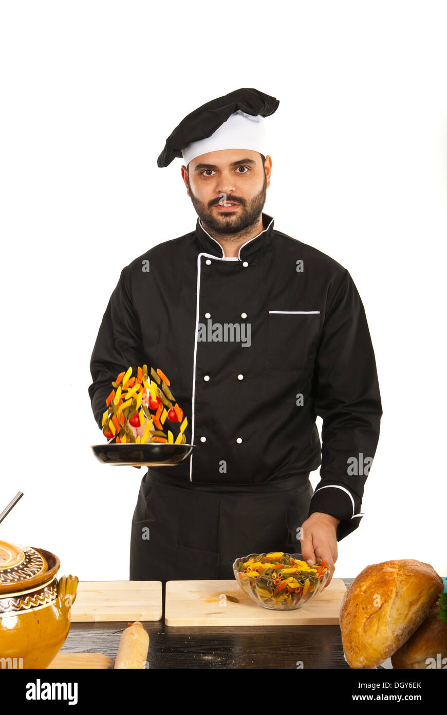 Chef tossing macaroni with tomatoes in kitchen Stock Photo - Alamy