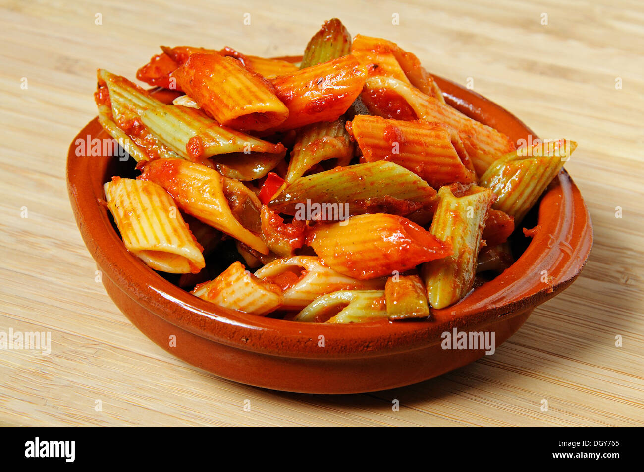 Multi-coloured Penne pasta in tomato sauce Stock Photo - Alamy