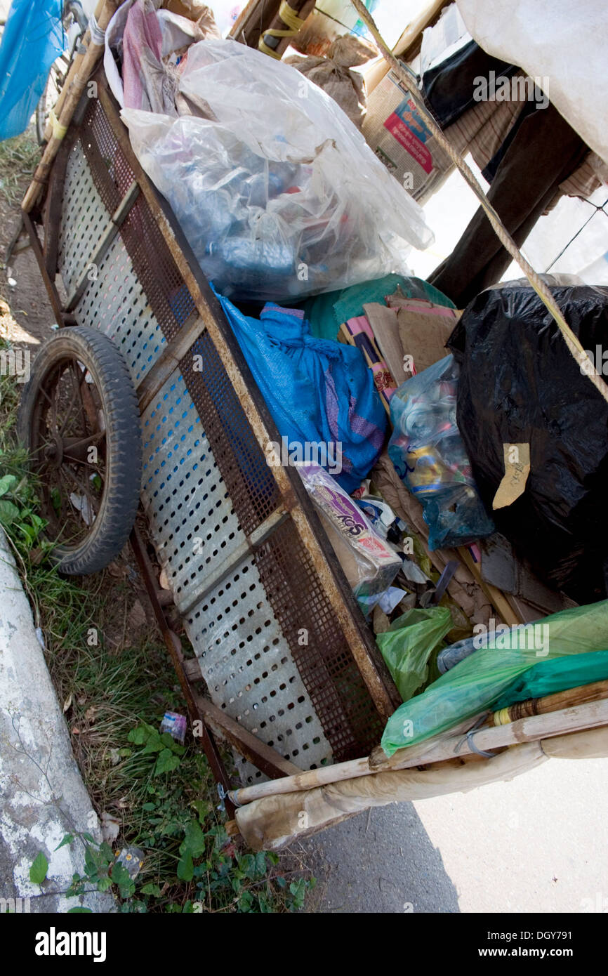 A homemade cart used by a man to collect recyclable material is sitting ...