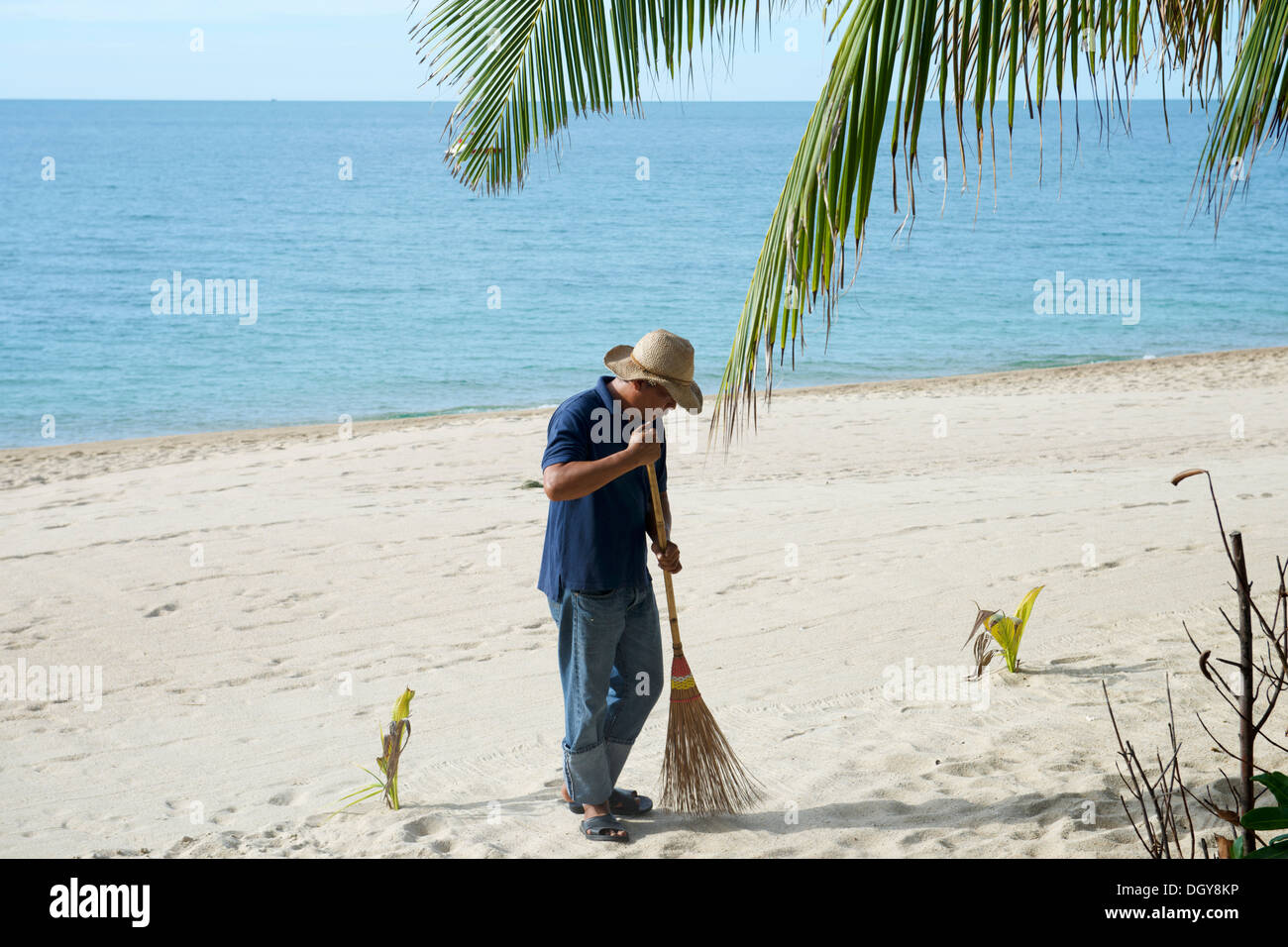 Man sweeping beach hi-res stock photography and images - Alamy