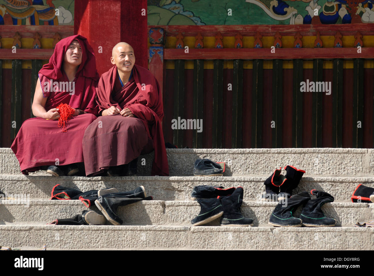Tibetan monks wearing robes of the Gelug or Gelug-pa Order sitting ...