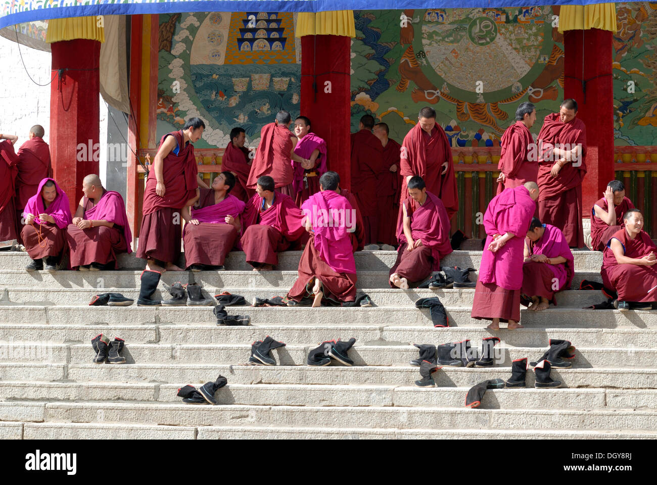 Tibetan monks wearing robes of the Gelug or Gelug-pa Order sitting ...