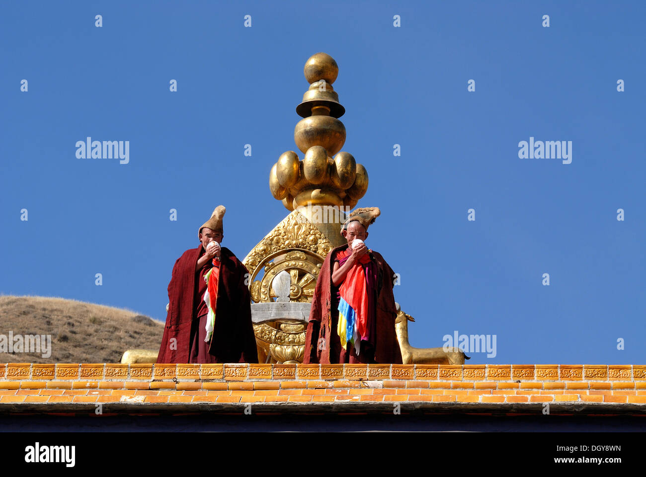 Tibetan monks wearing robes and yellow hats of the Gelug Order or ...