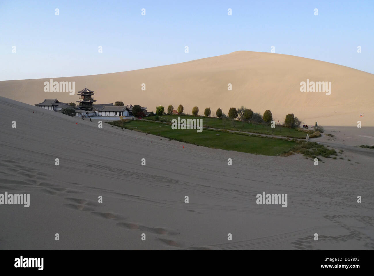 View from the sand dunes of the Gobi Desert to the Crescent Lake with a ...