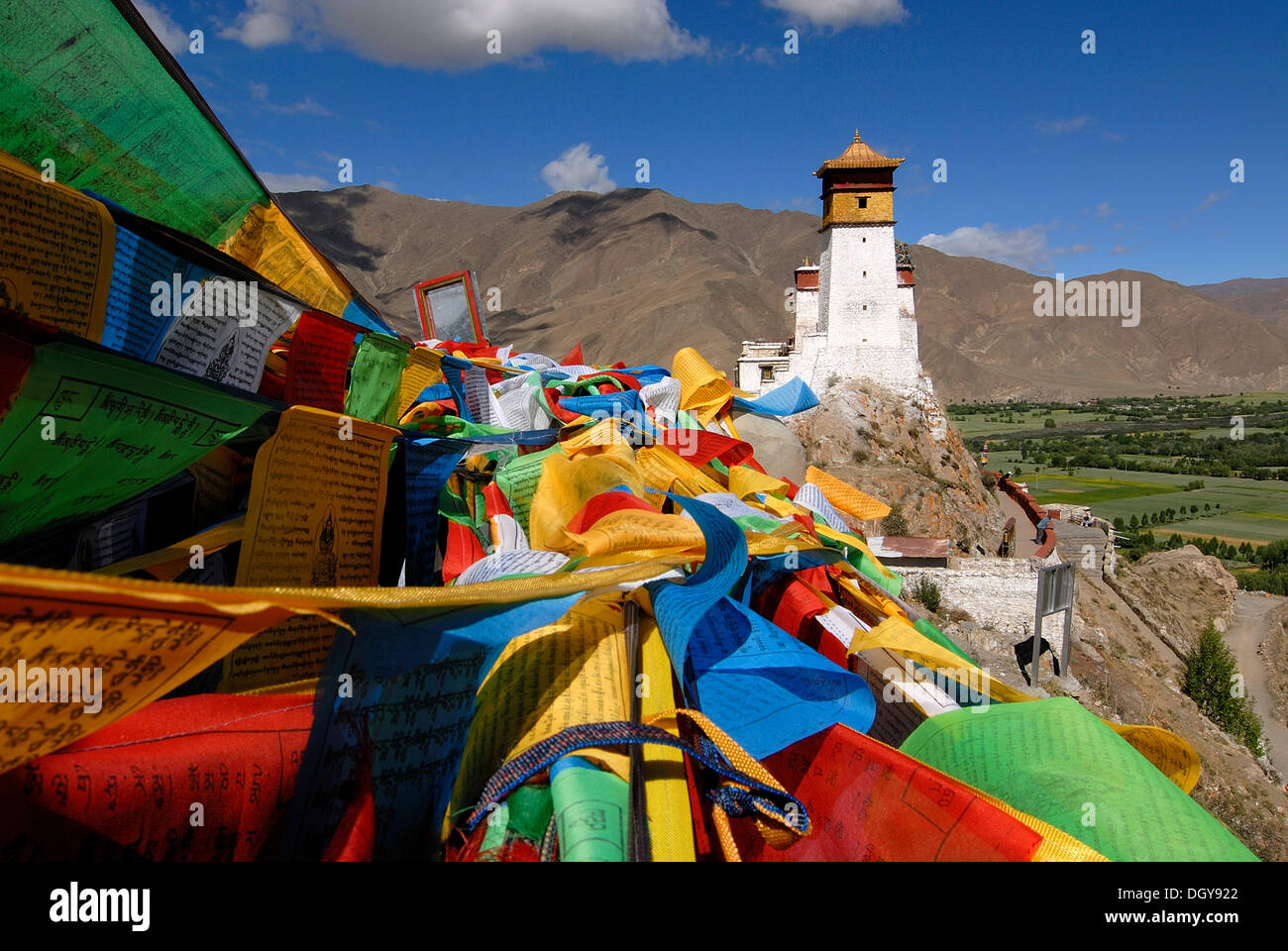 Prayer flags are flying on Yumbulagang Palace above the Yarlung Valley ...