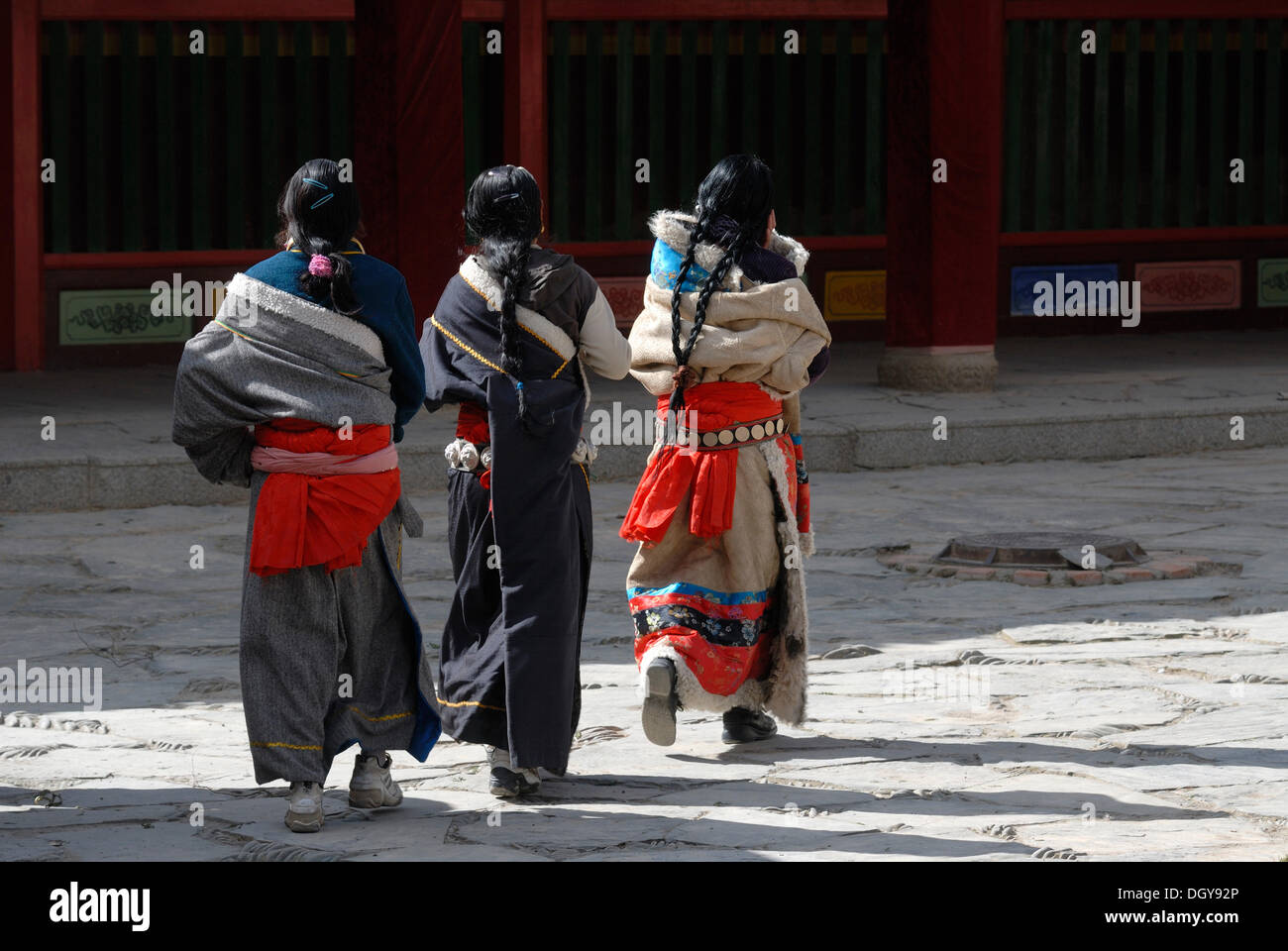 Tibetan women in traditional costume in front of the assembly hall or ...