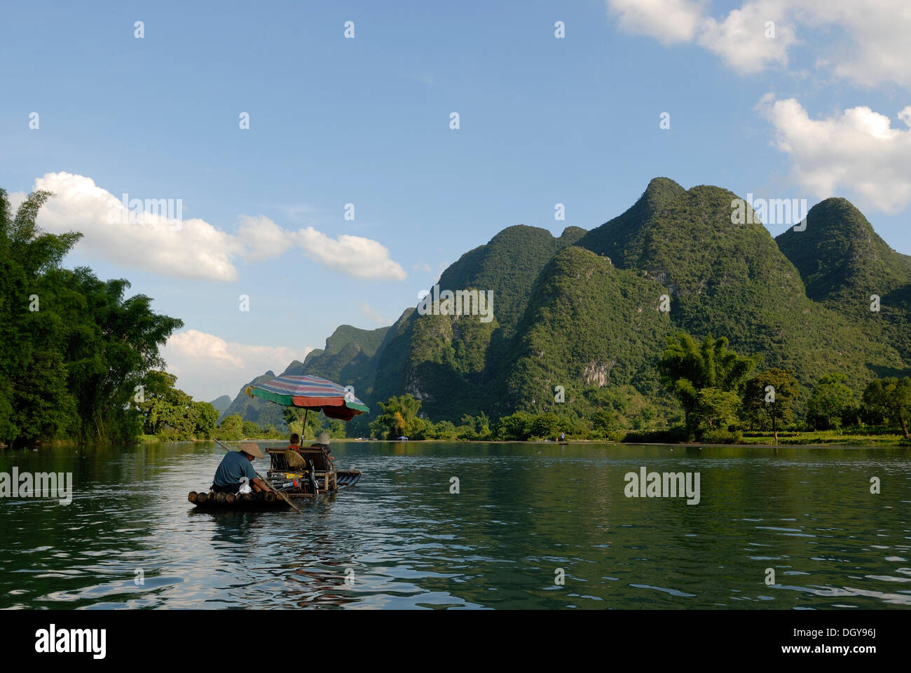 Western tourists on bamboo raft on the Yulong river in the karst ...