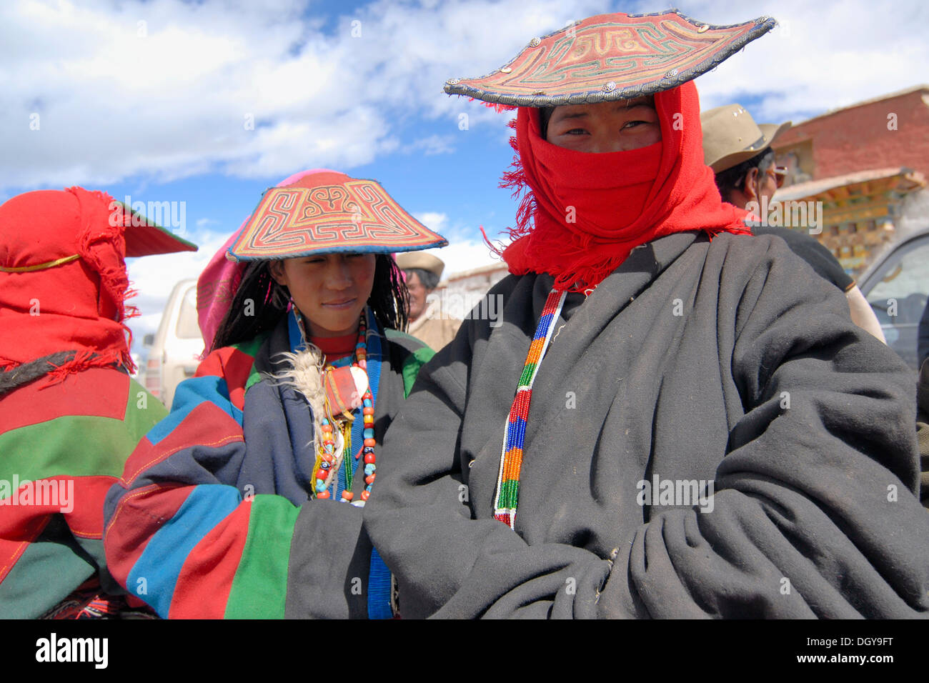 Tibetan women with traditional head coverings, fur caps and peaked caps ...