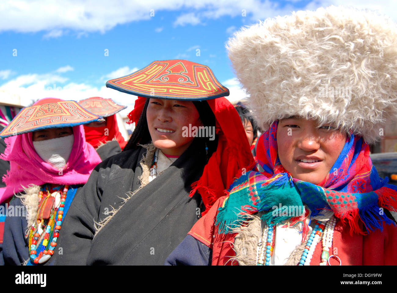 Tibetan women with traditional head coverings, fur caps and peaked caps ...