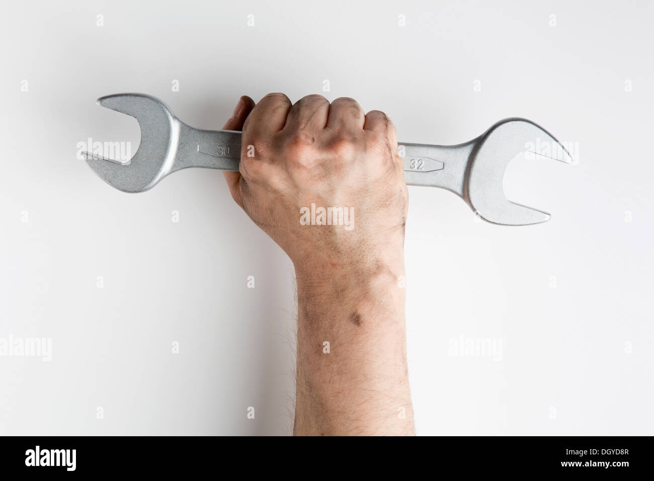 A fist holding a wrench up triumphantly Stock Photo - Alamy