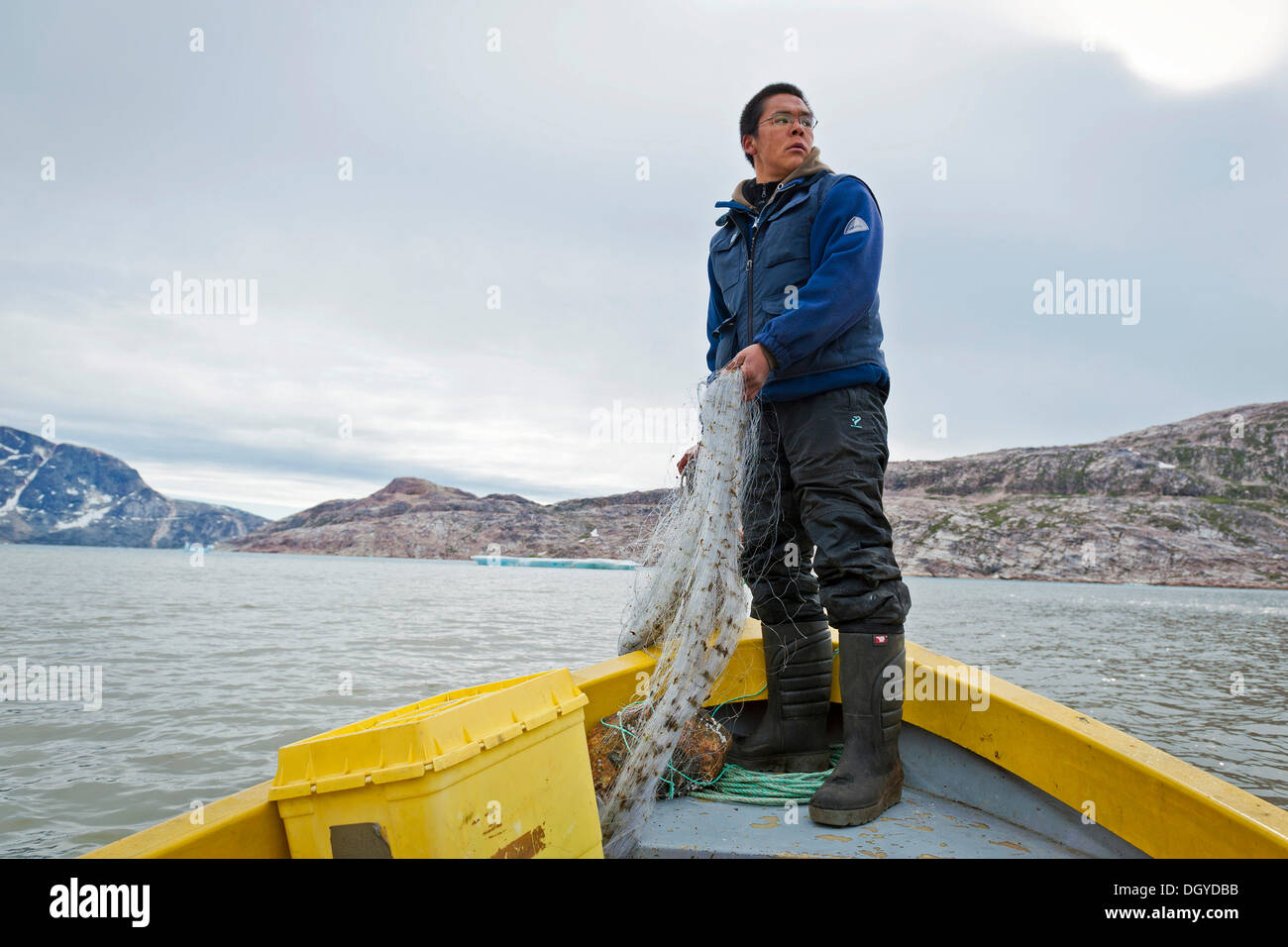 Inuit hunter fishing, near the Inuit settlement of Tiniteqilaaq ...