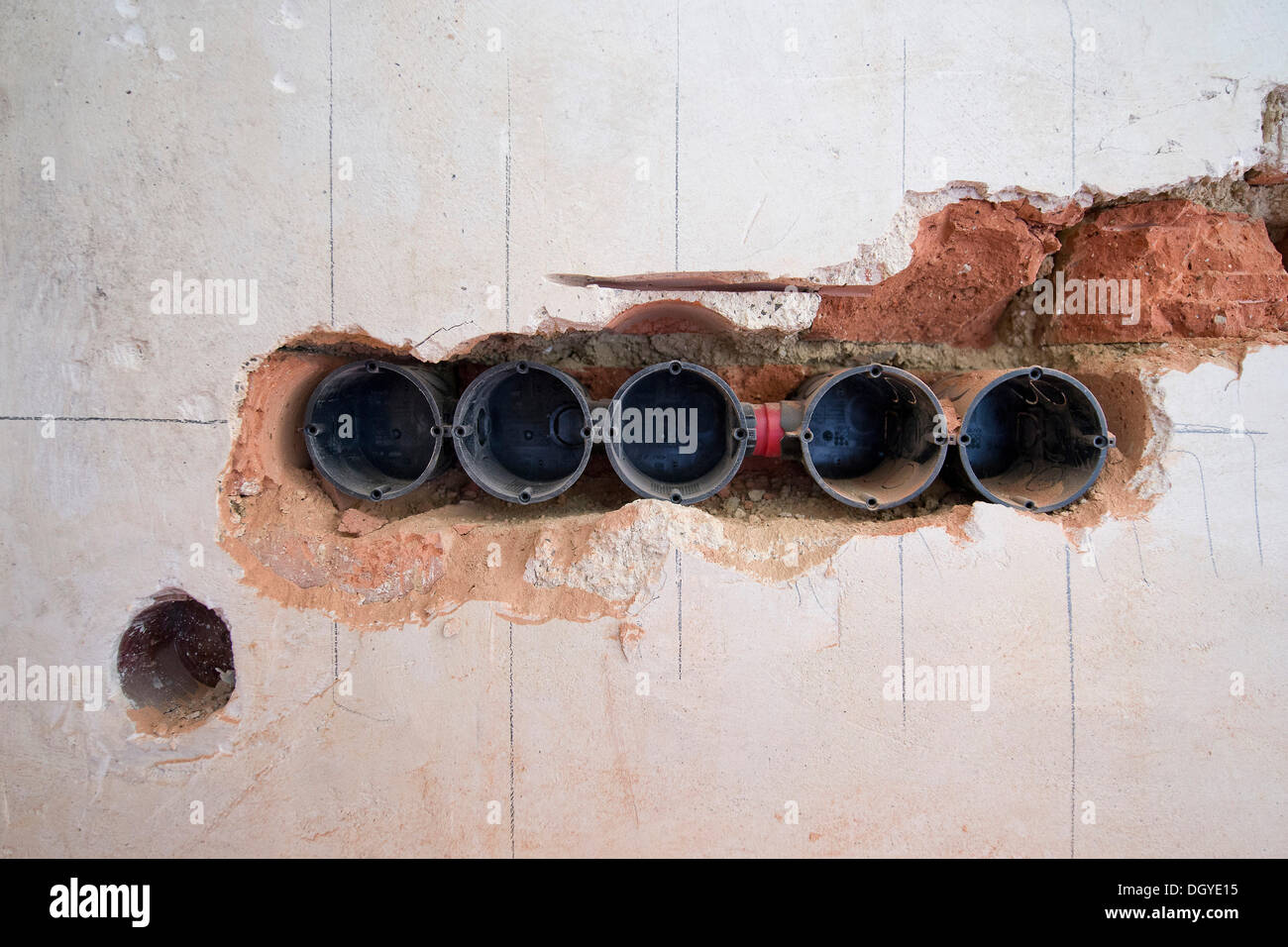 Preparatory work on a wall for installing new cable canals and sockets ...