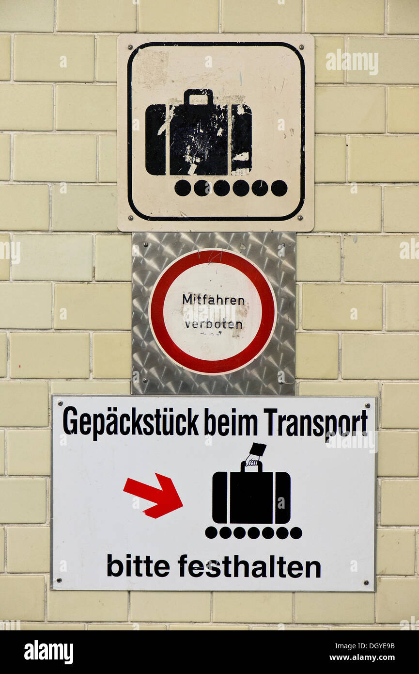 Sign, lettering "Gepaeckstueck beim Transport bitte festhalten", German ...