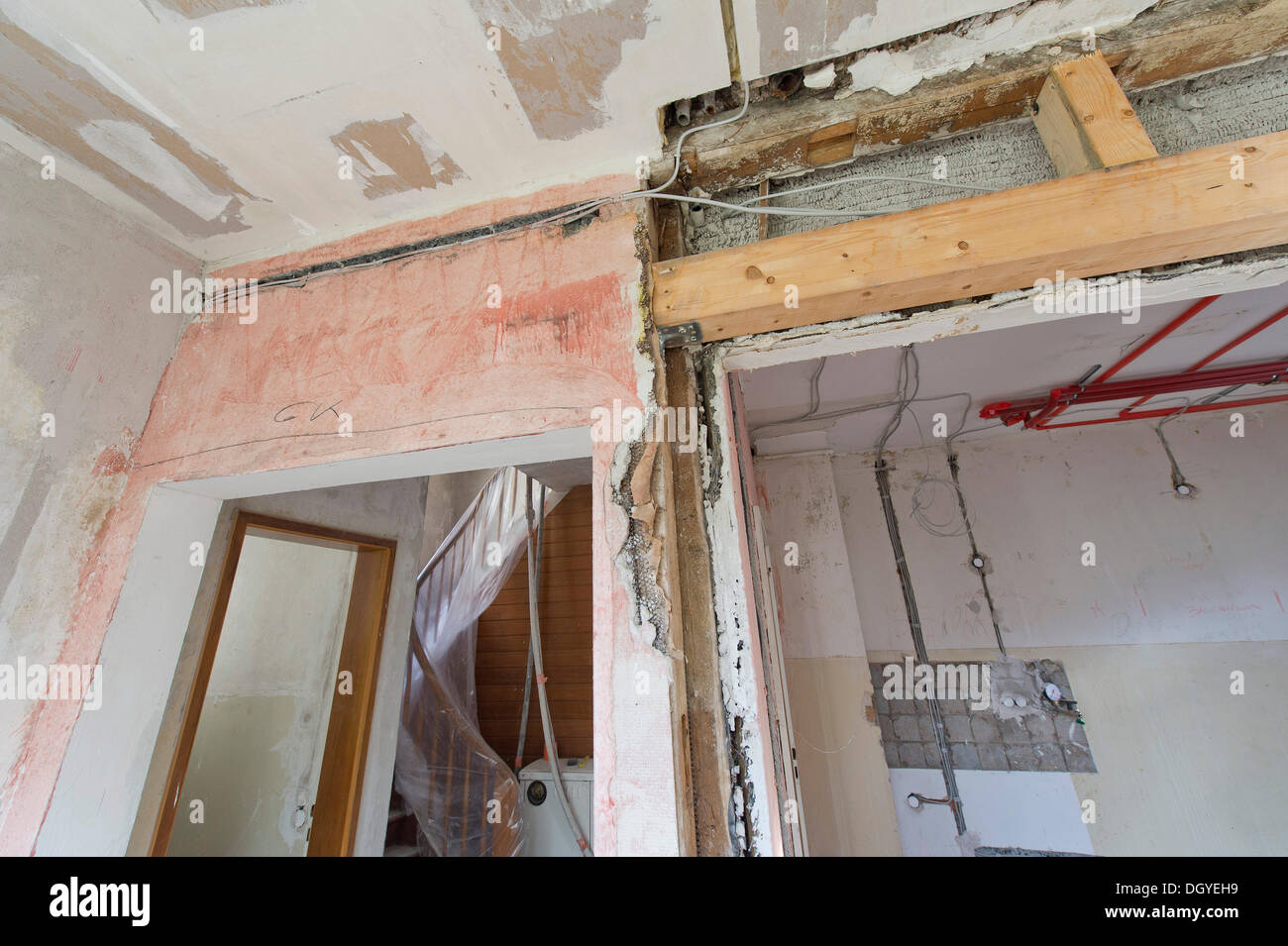 Opening in a wall with a new beam construction, renovation of an old ...