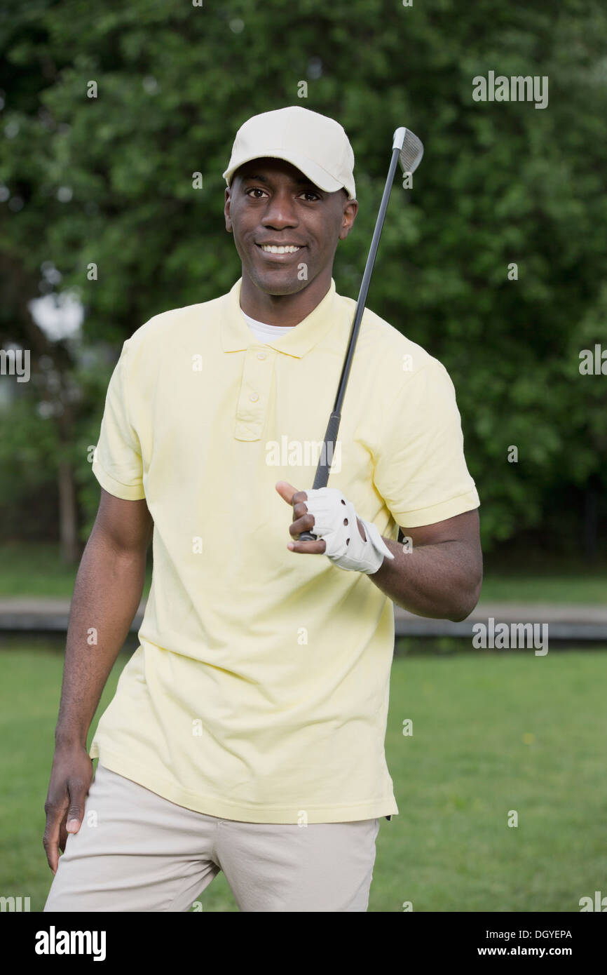 Man relaxing on golf course Stock Photo - Alamy