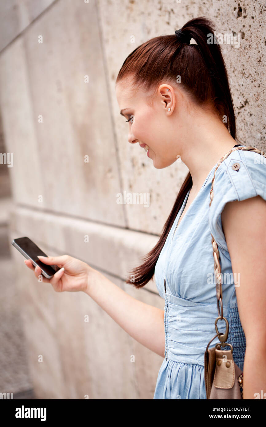 attractive young woman with smartphone camera photos outdoor in summer ...