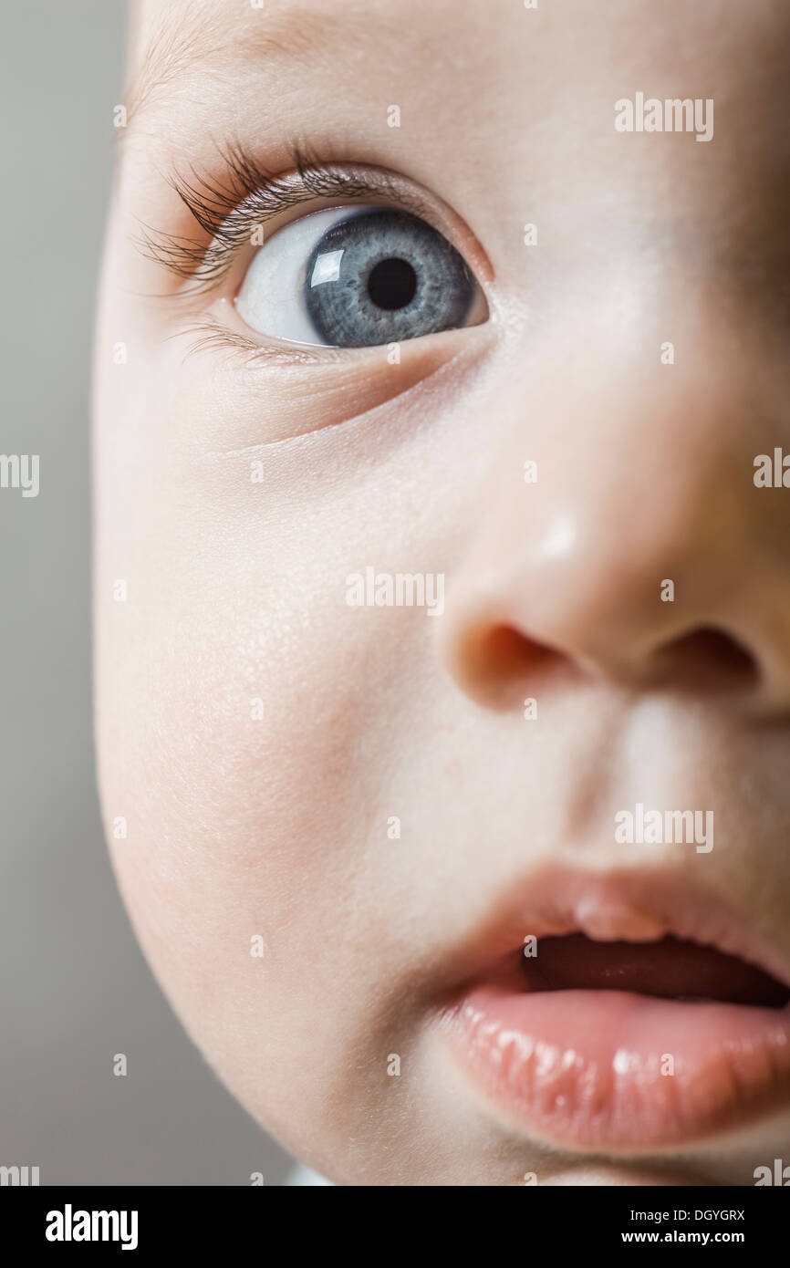 A baby boy looking curiously into the camera, extreme close-up Stock ...