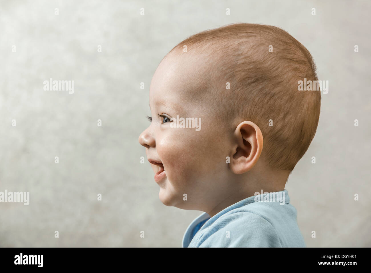 A carefree baby smiling and laughing while looking off camera Stock ...