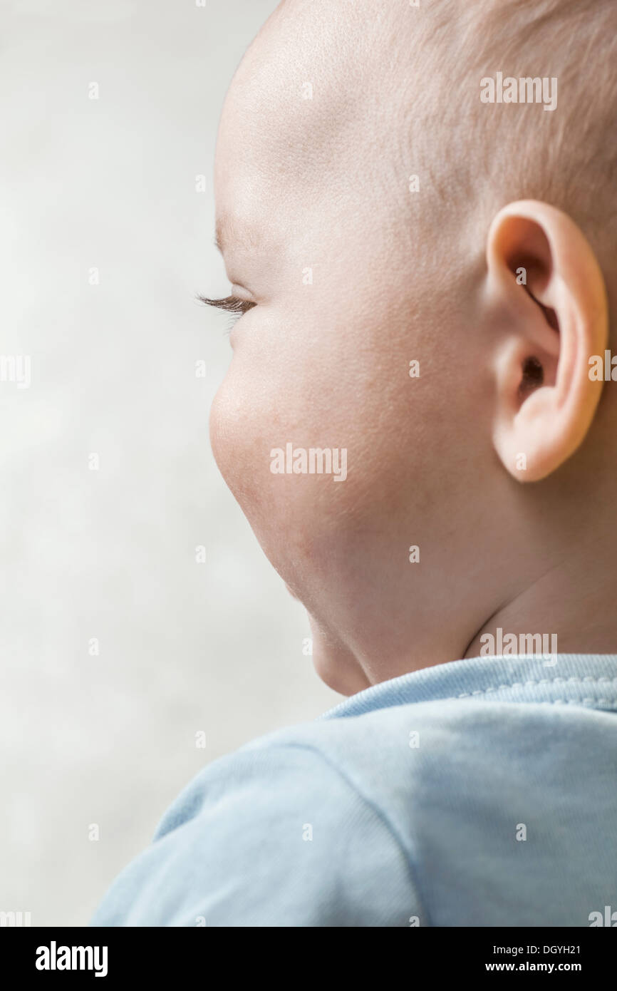 A carefree baby boy looking off camera Stock Photo - Alamy