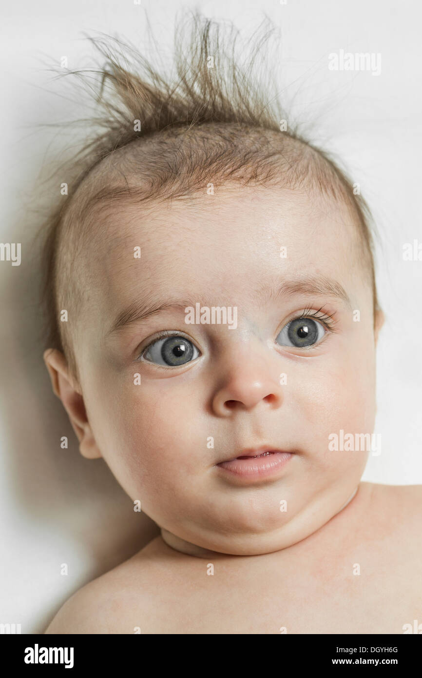 A baby boy looking away curiously Stock Photo - Alamy