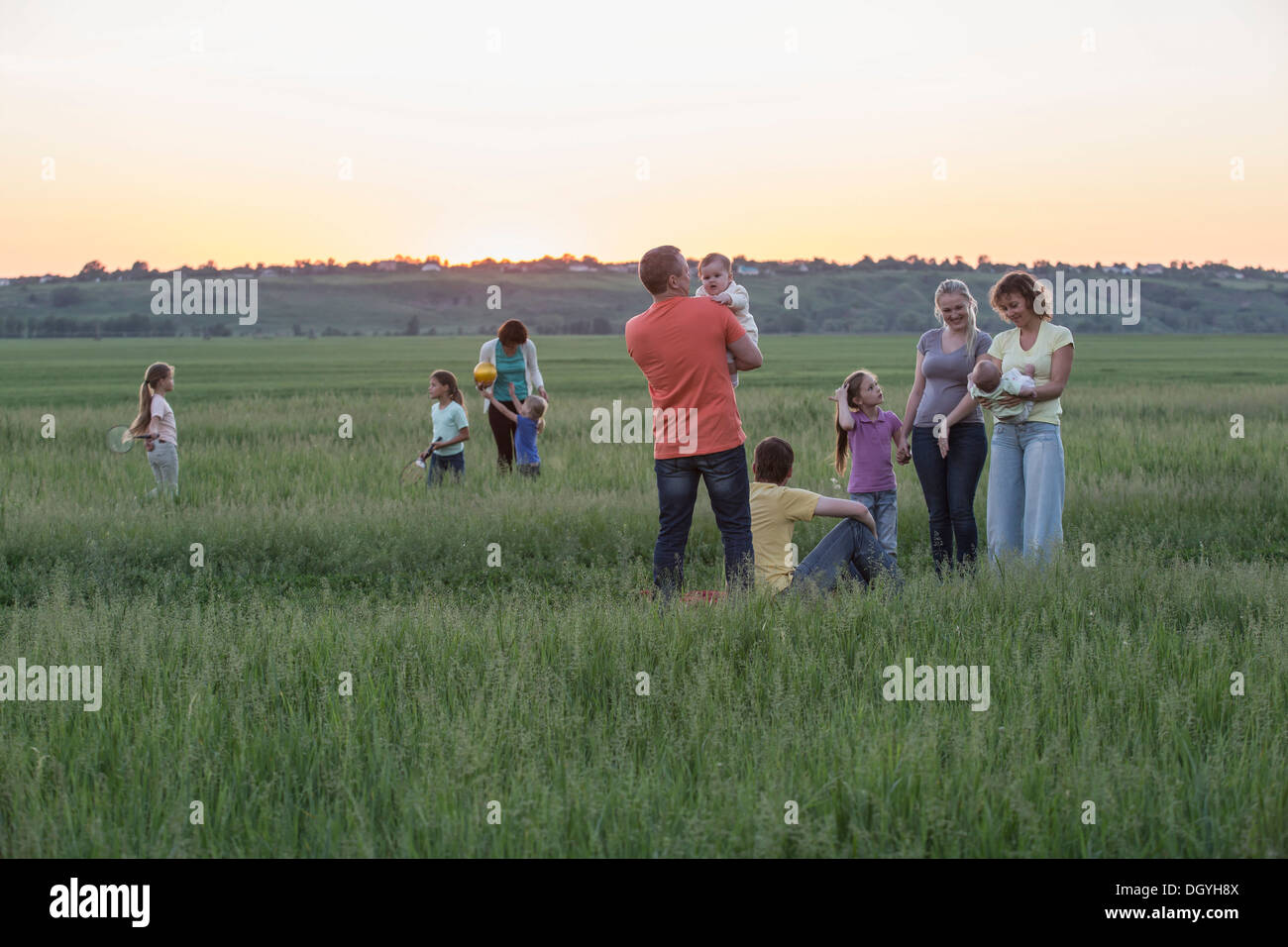 Families relaxing in a field in a rural setting Stock Photo - Alamy