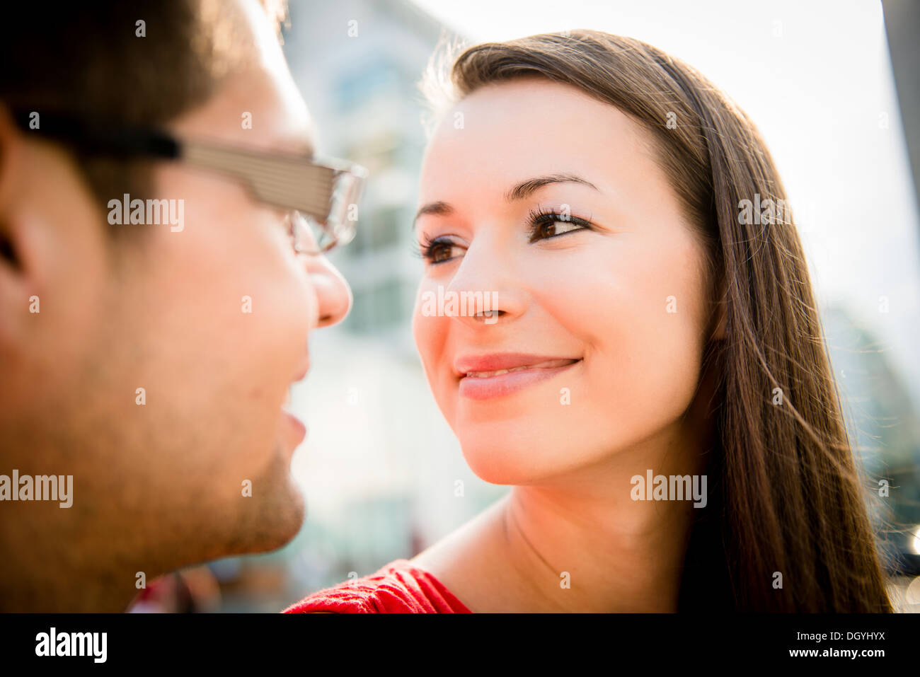 Young couple in love looking to each others eyes - outdoor in street ...