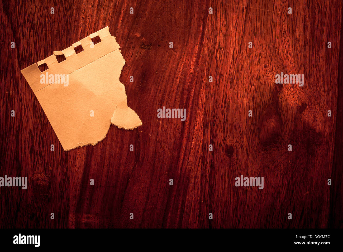 Piece of torn paper on solid wood Stock Photo - Alamy