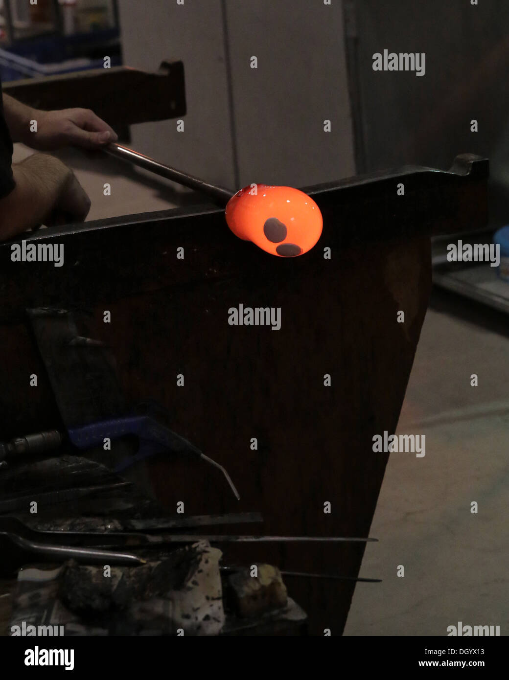 Making glass paperweights using the pipe or punty which the glass rides ...