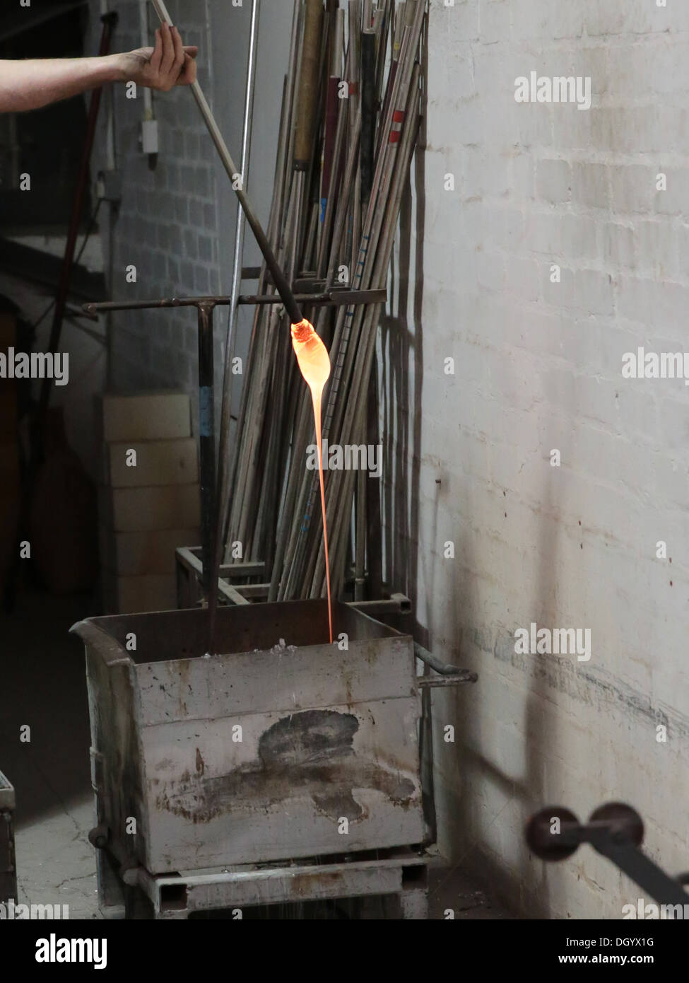 Making glass paperweights - removing excess molten glass from the ...