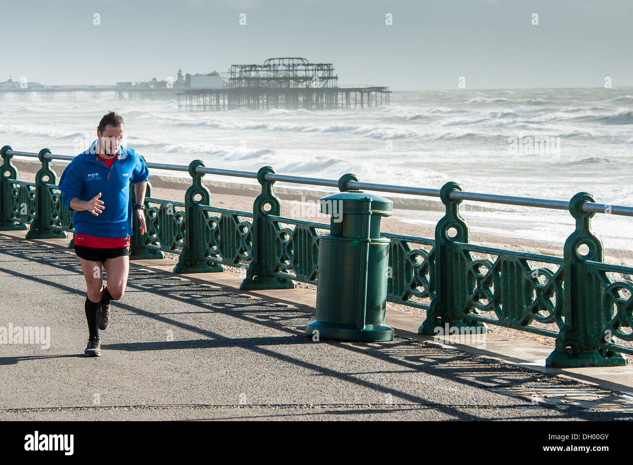 Brighton, UK. 28th Oct 2013. A runner struggles against the wind in the ...