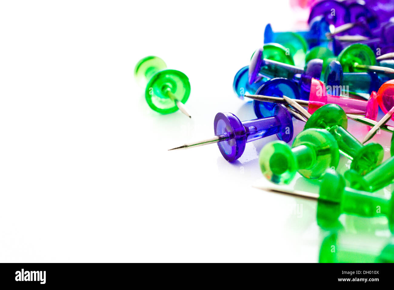 Multicolored thumbtacks in a pile on a white background Stock Photo - Alamy