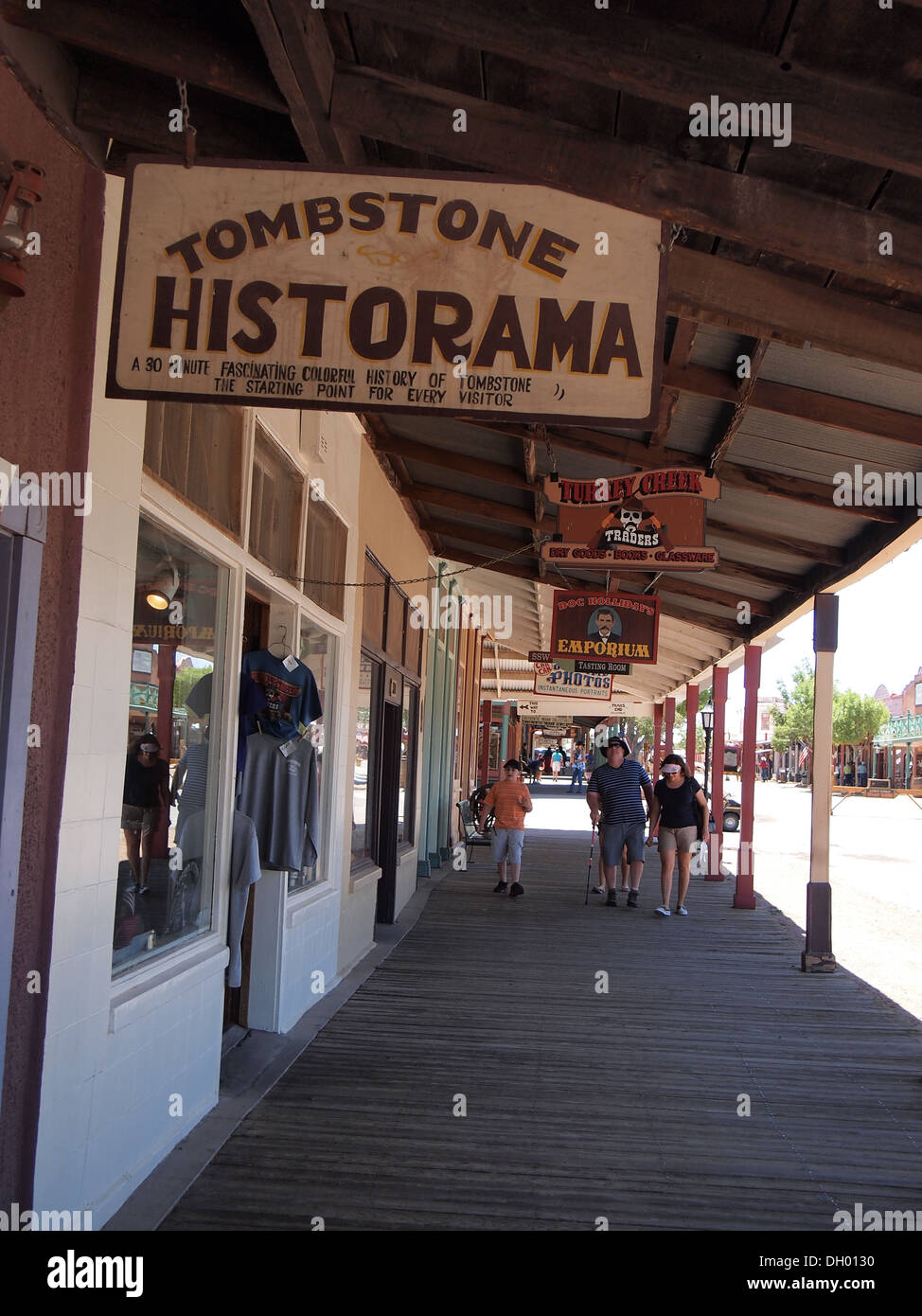 Tourists walking along covered boardwalk in the historical American Old ...
