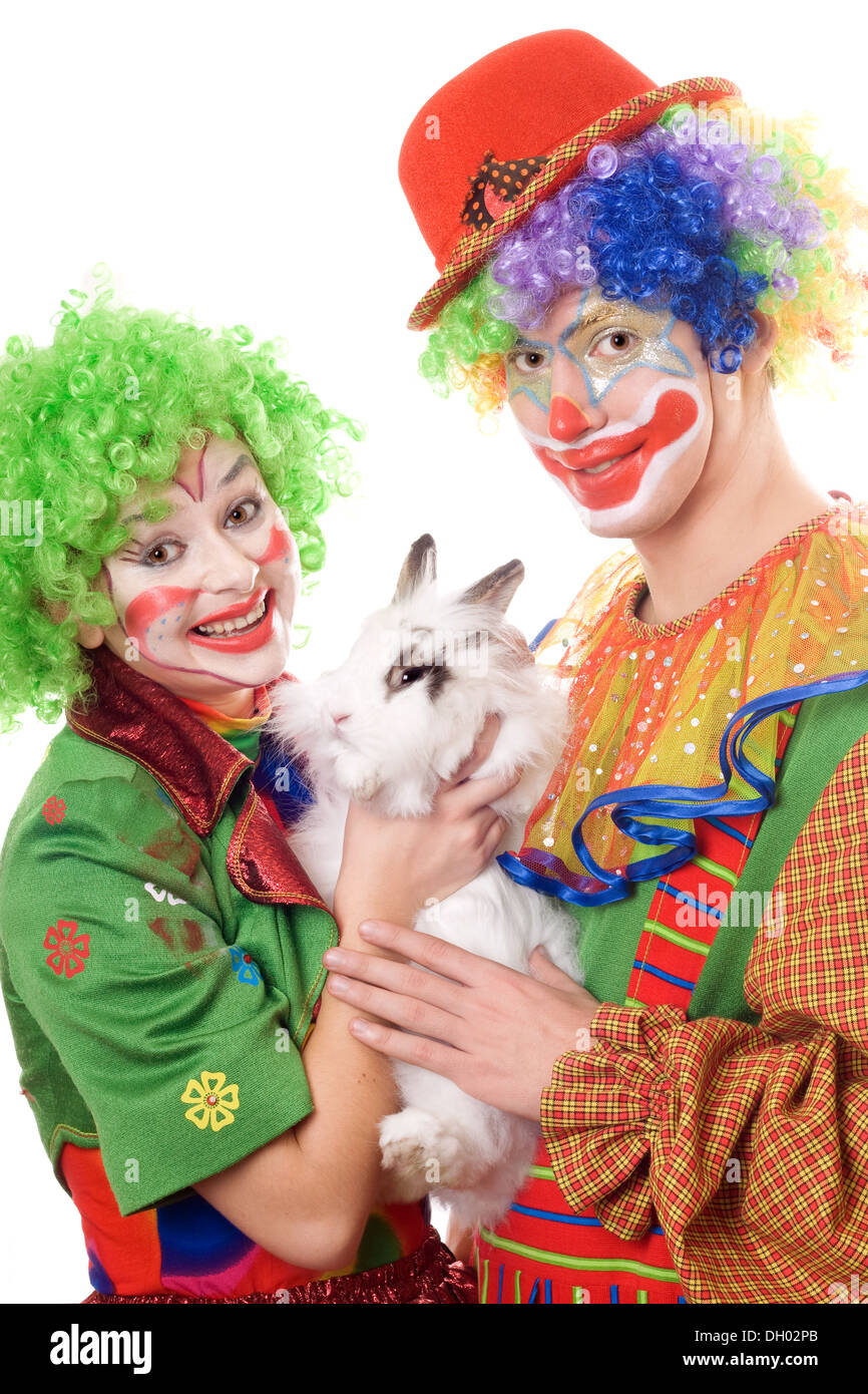 Two smiling clown with a white rabbit Stock Photo - Alamy