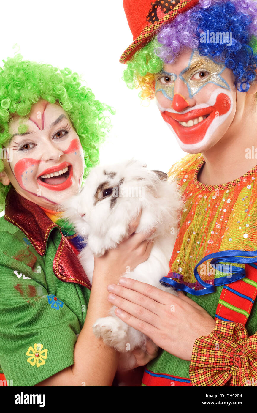 Two cheerful clown with a white rabbit. Isolated Stock Photo - Alamy