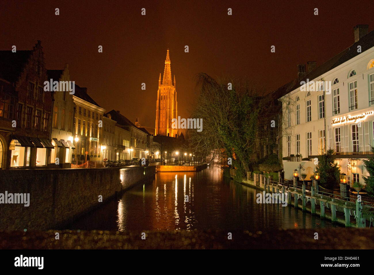 Bruges by night, looking along a canal to Church of Our Lady, Bruges ...