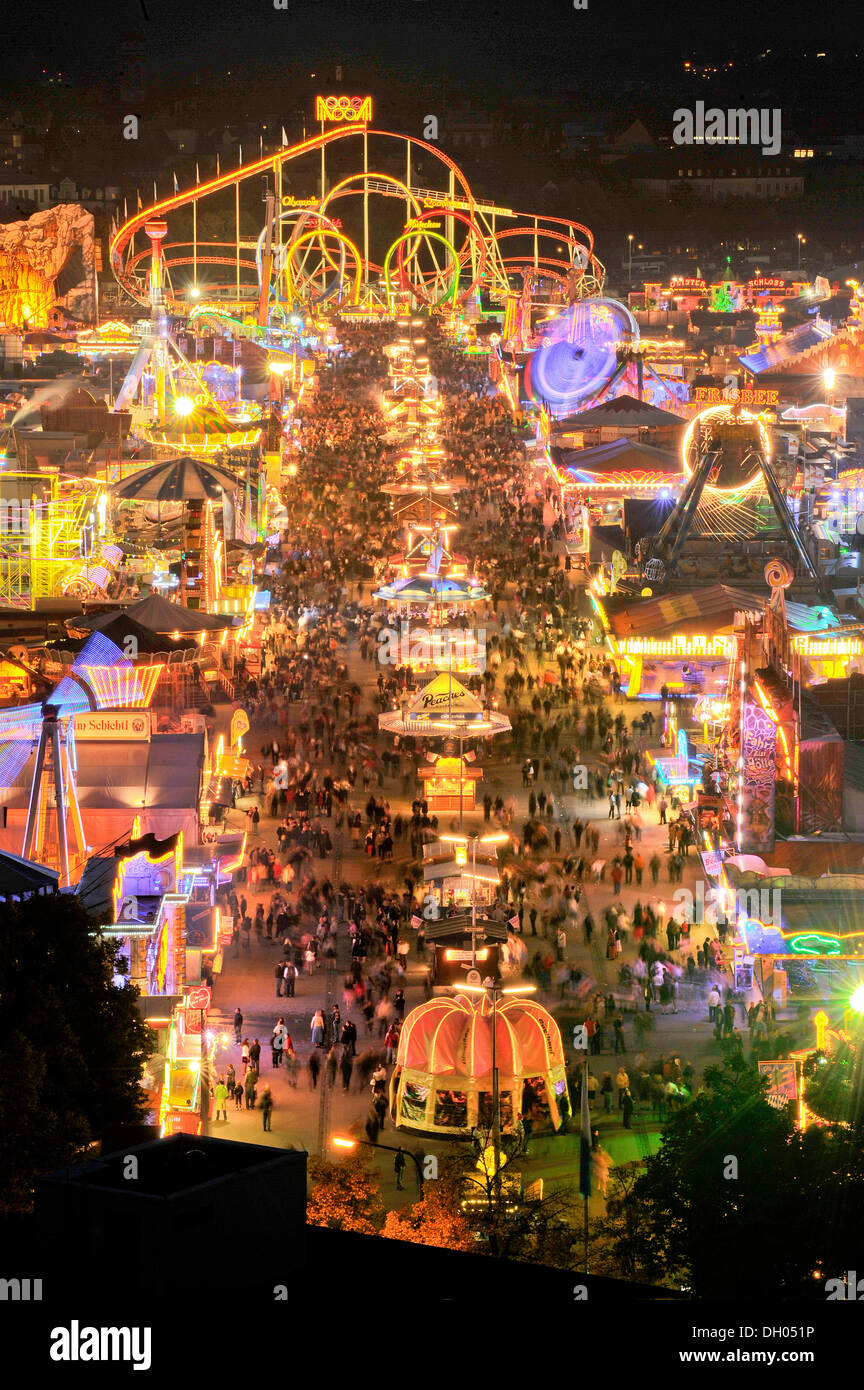 View of the Oktoberfest festival at night, with illuminated stalls ...